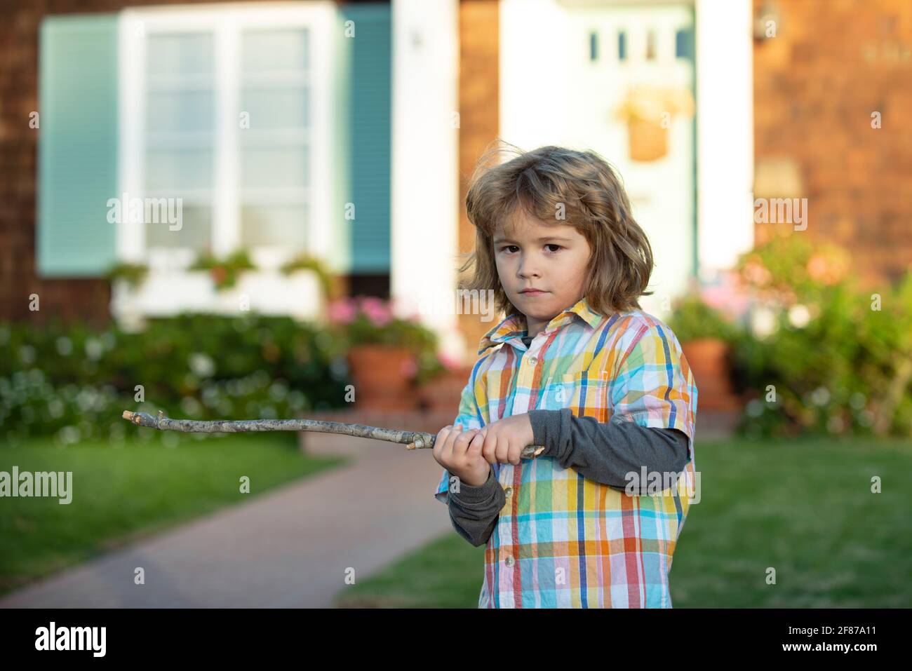 Kids aggression. Negative child emotion. Angry boy with stick. Kid ...