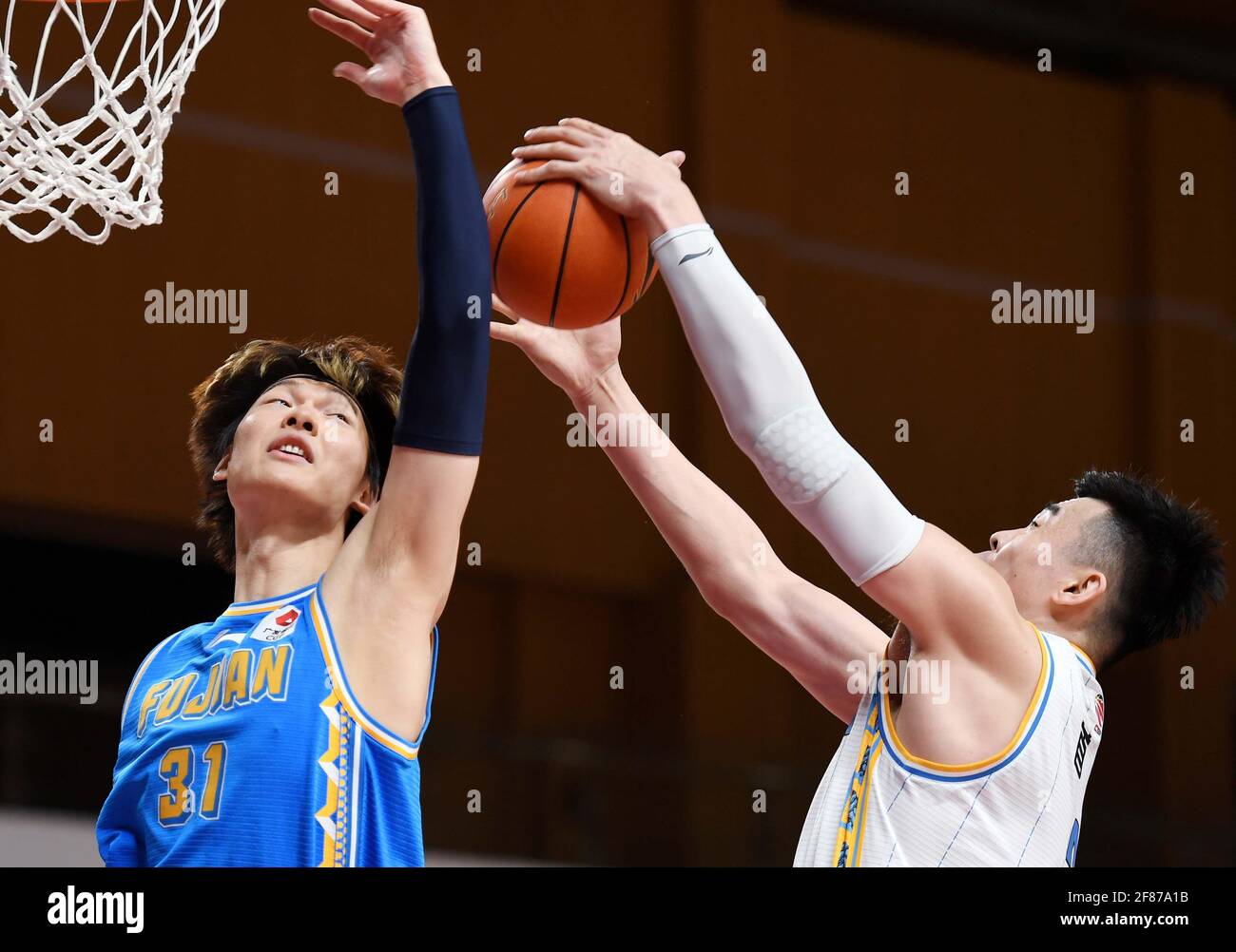 Zhuji, China's Zhejiang Province. 12th Apr, 2021. Wang Zhelin (L) of Fujian Sturgeons defends Li ...