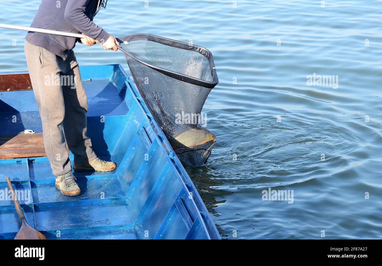 the fisherman pulls the net out of the water Stock Photo - Alamy