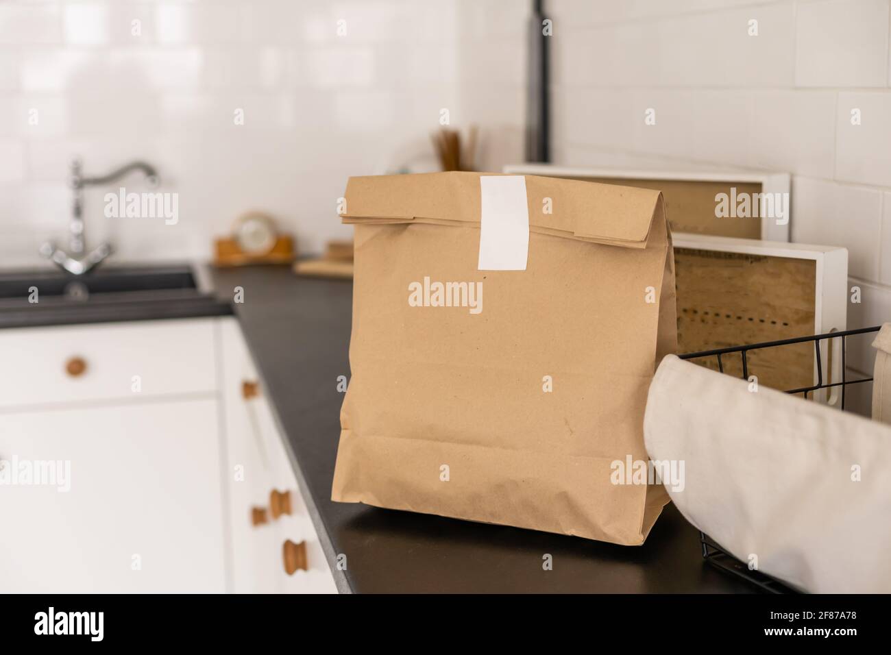 Paper packages with groceries on kitchen table Stock Photo - Alamy