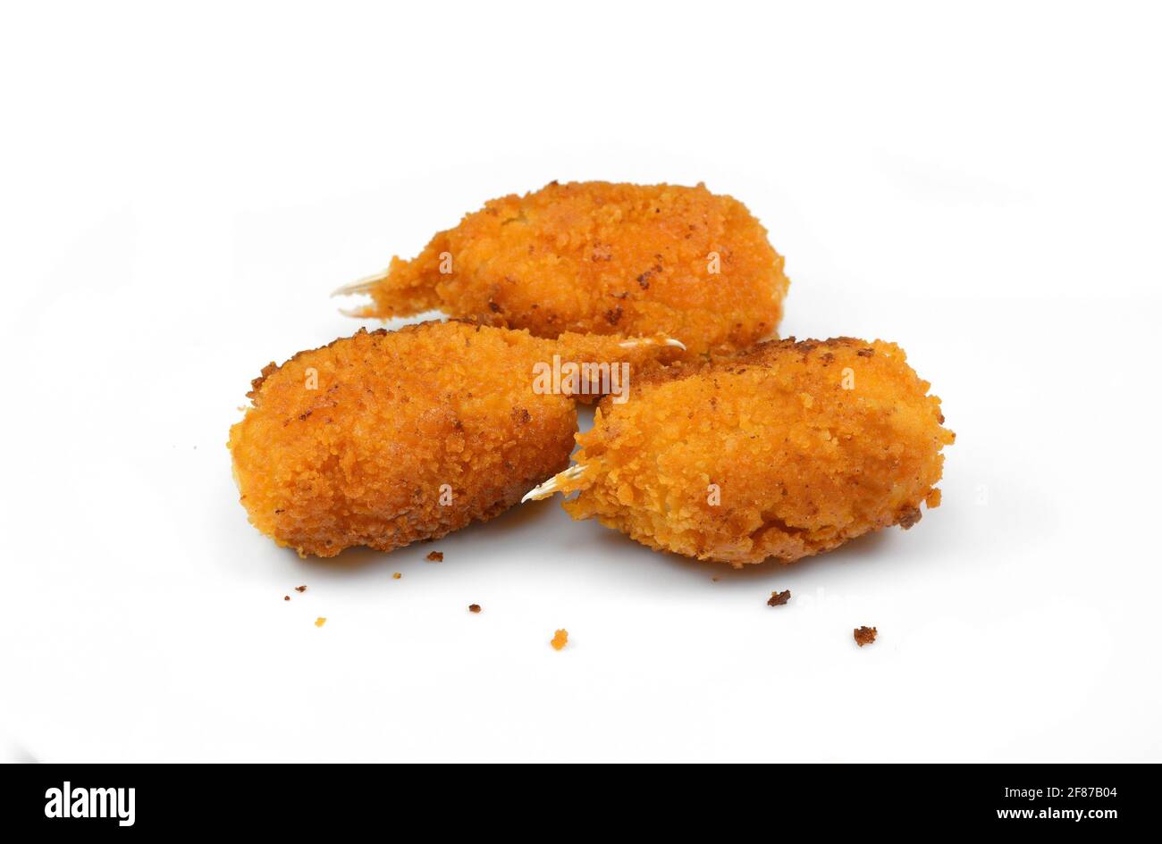 Three fried breaded surimi crab claws, in perspective, isolated on ...