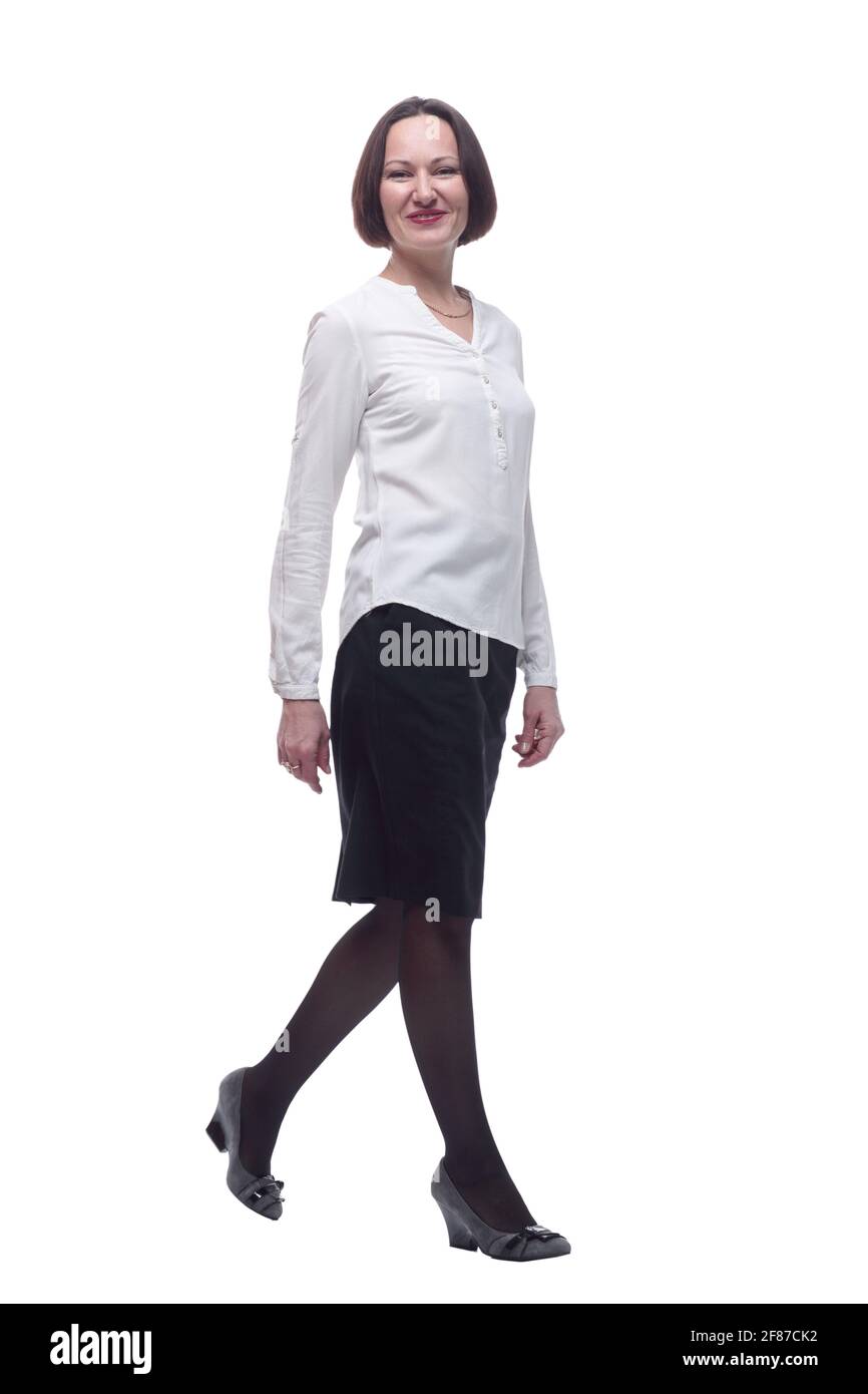smiling business woman striding forward .isolated on a white background ...