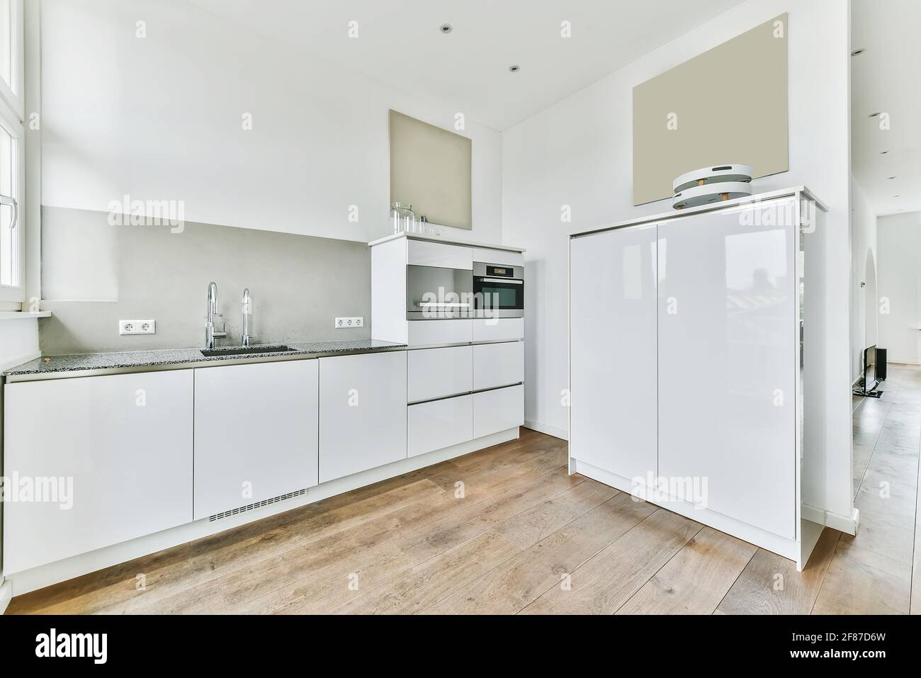Light kitchen with stylish portraits Stock Photo - Alamy