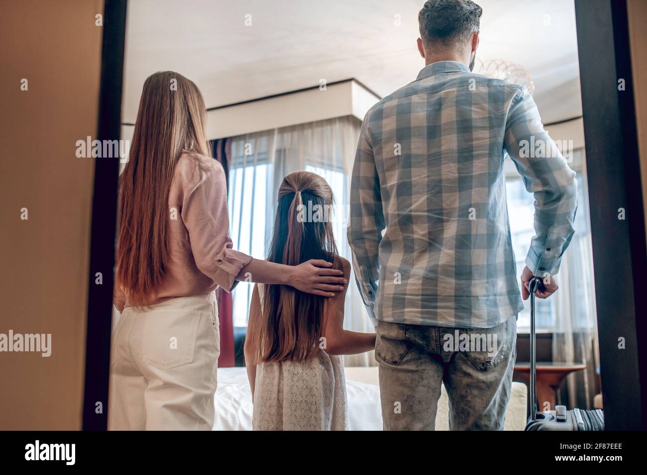 Family arrived to the hotel and entering the room Stock Photo - Alamy