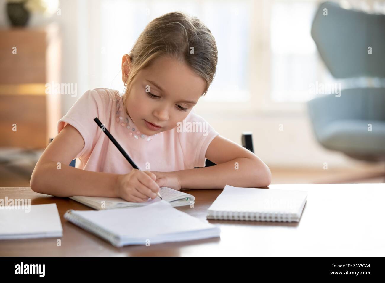 Smart little girl child do homework for school Stock Photo - Alamy