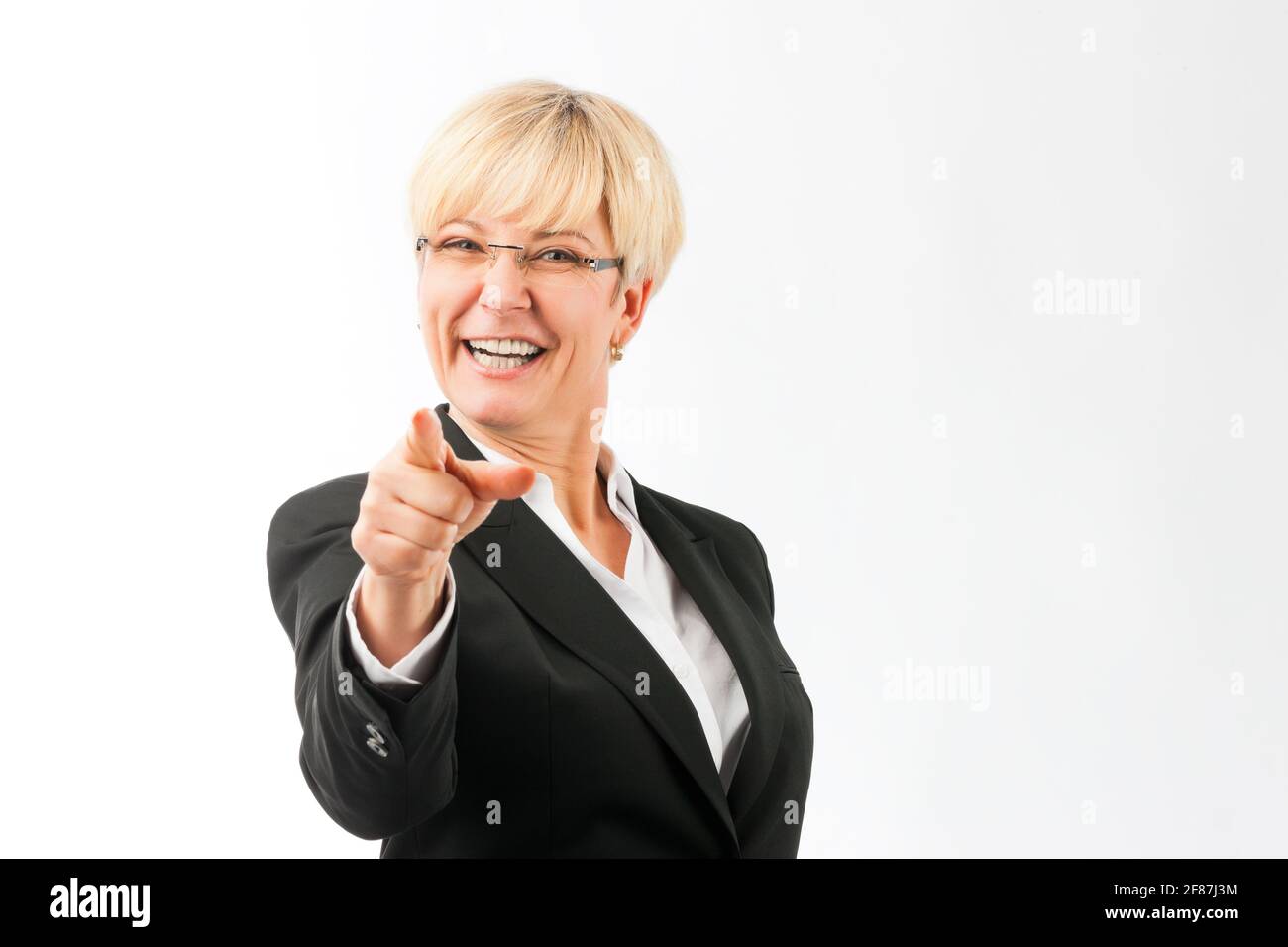 Mature woman point finger on the viewer, studio shoot Stock Photo - Alamy