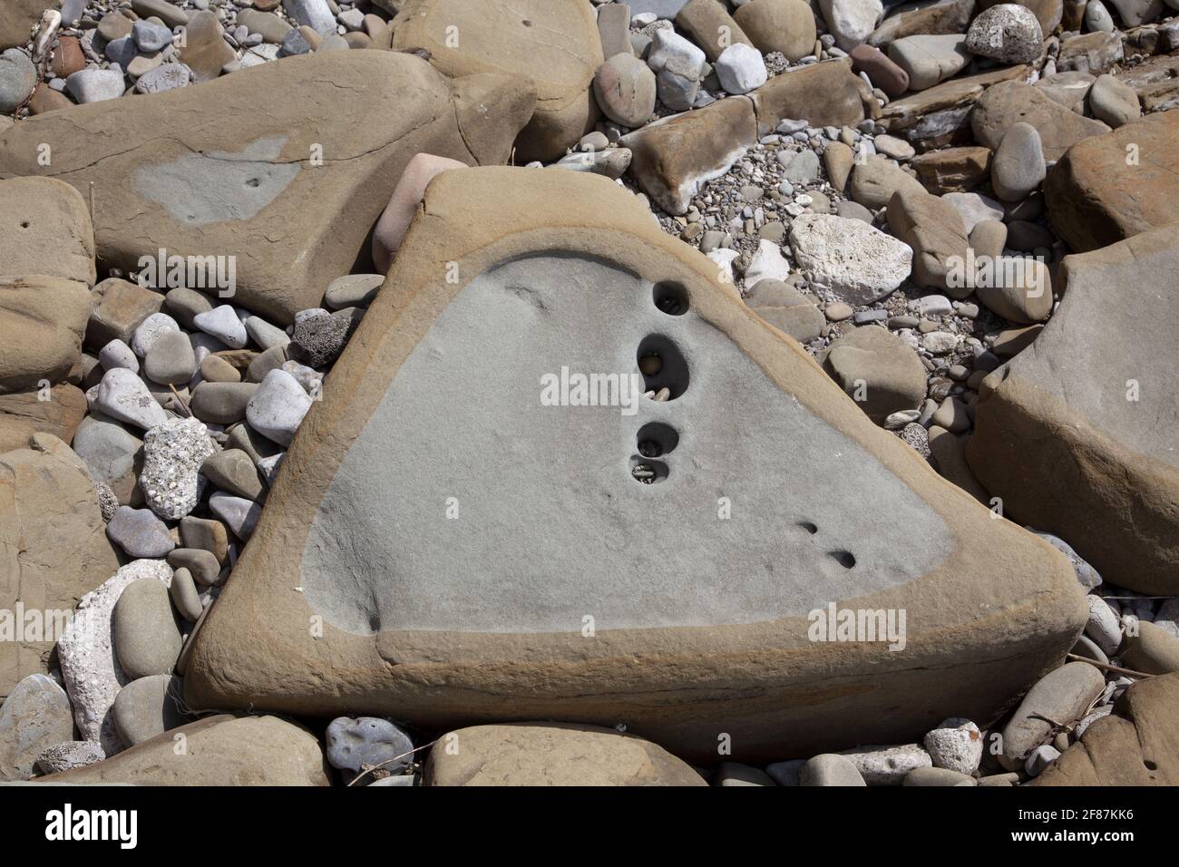Three Angle Shaped Stone on the Beach.Natural Triangle With Small Holes ...