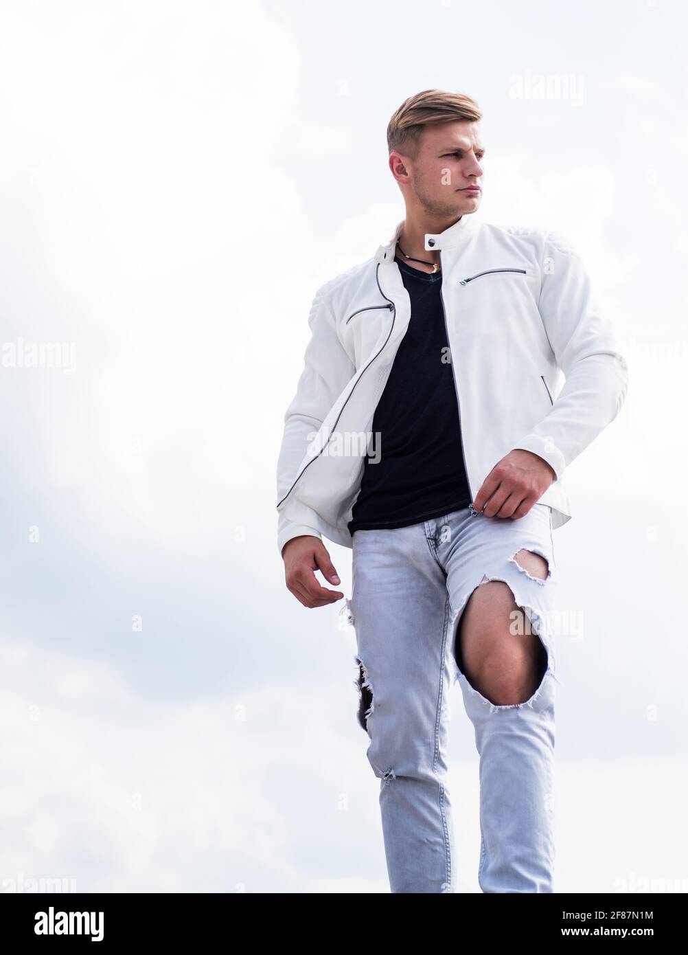 Single young guy in casual fashion wear travel idyllic cloudy sky ...