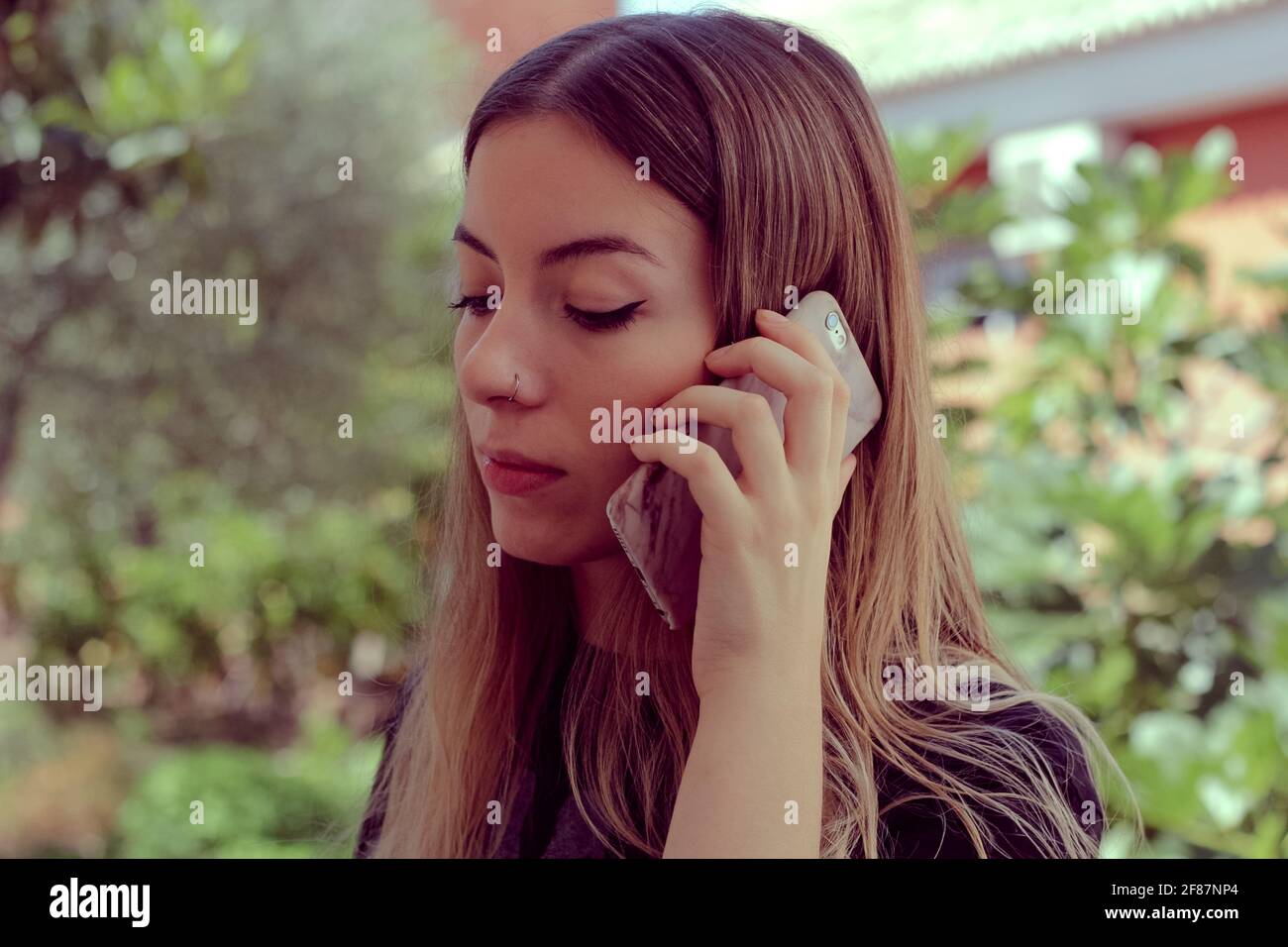 Young woman talking on cell phone Stock Photo - Alamy