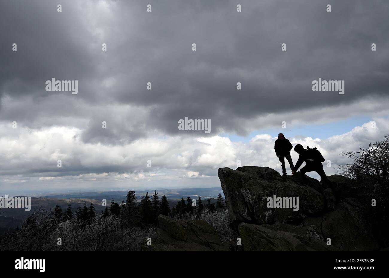 Schmitten, Germany. 12th Apr, 2021. Two hikers climb the Brunhildis ...