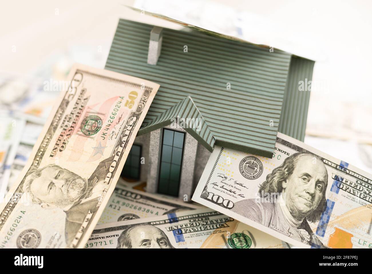 the layout of the house is on a pile of money Stock Photo - Alamy