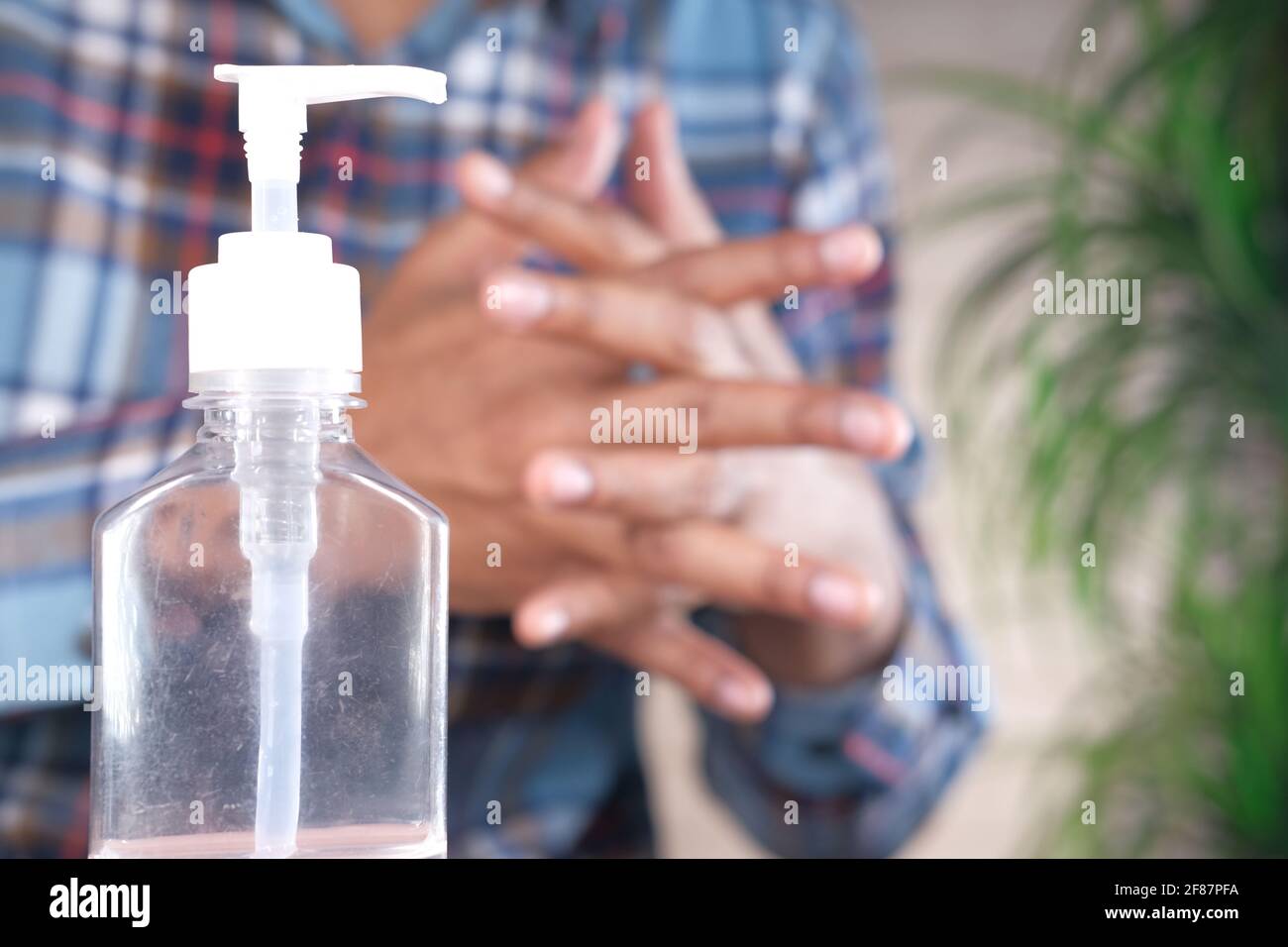 Using sanitizer liquid for preventing corona virus Stock Photo - Alamy