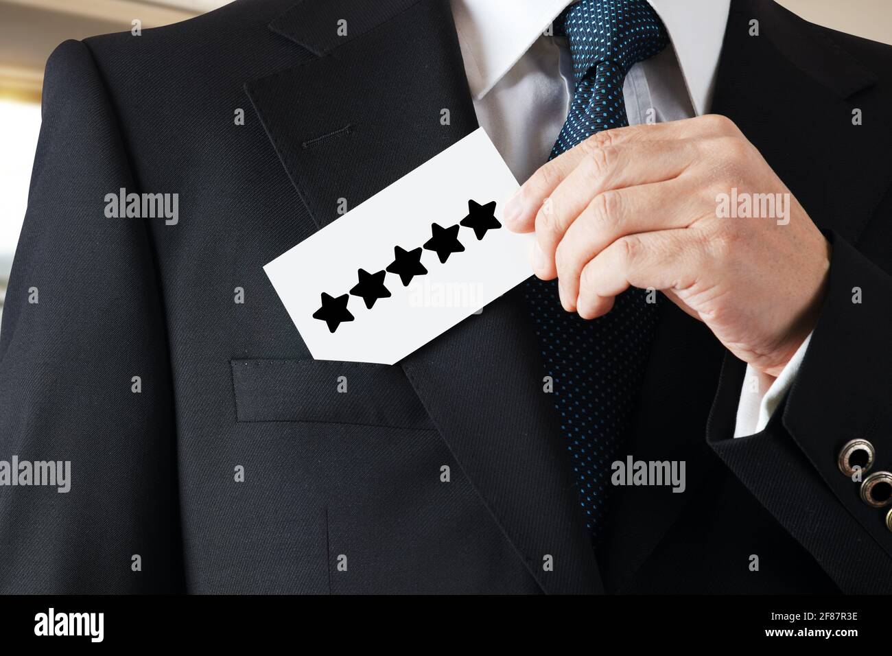 Businessman takes out a business card from his pocket with the five ...