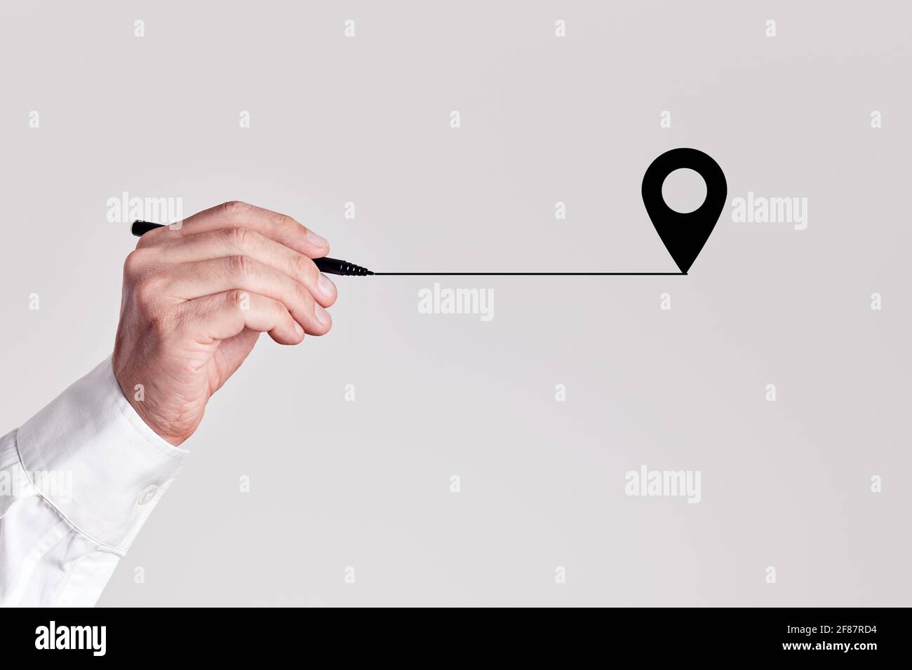 Businessman with a pen draws a line coming from the pin map location ...