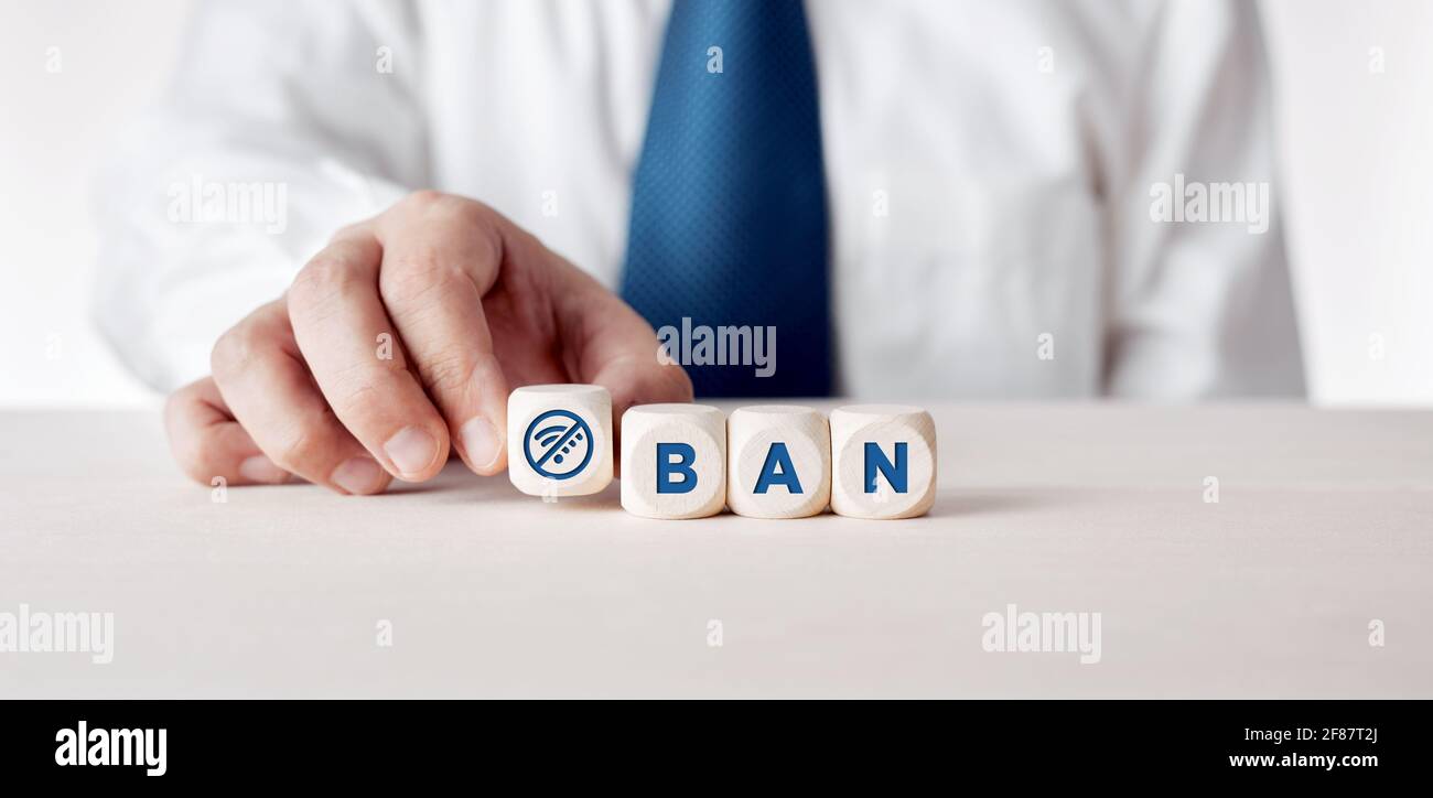 Businessman placing the wooden cubes with the word ban. Internet bans ...