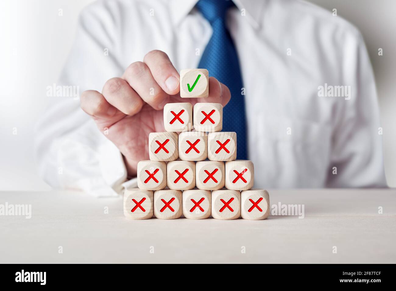 Businessman places the cube with the check mark symbol on top of a ...