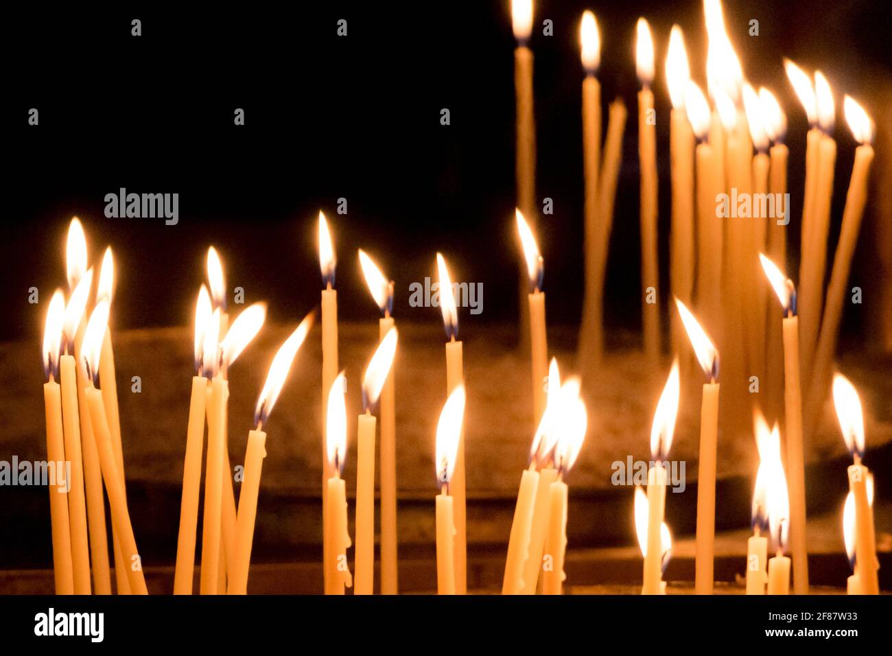 Group of yellow candles in church for faith resurrection prayer ...