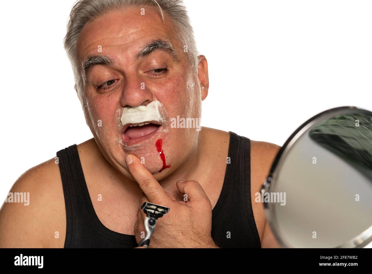 nervous middle aged man with blood on his face on white background ...