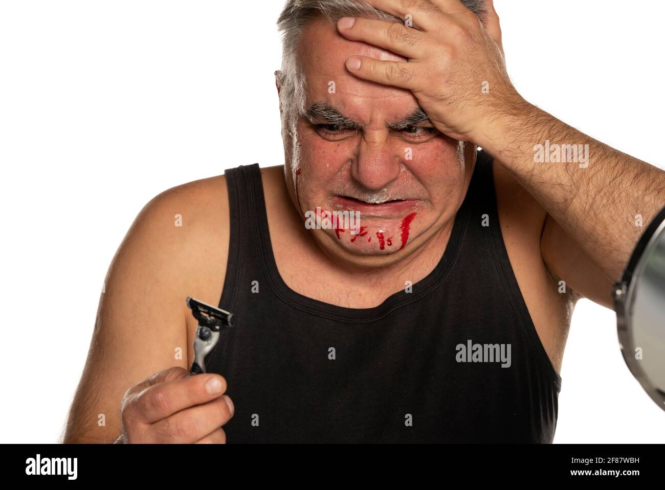 nervous middle aged man with blood on his face on white background ...