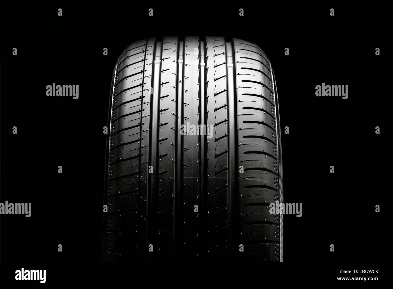 summer car tire tread, front view, black background Stock Photo - Alamy