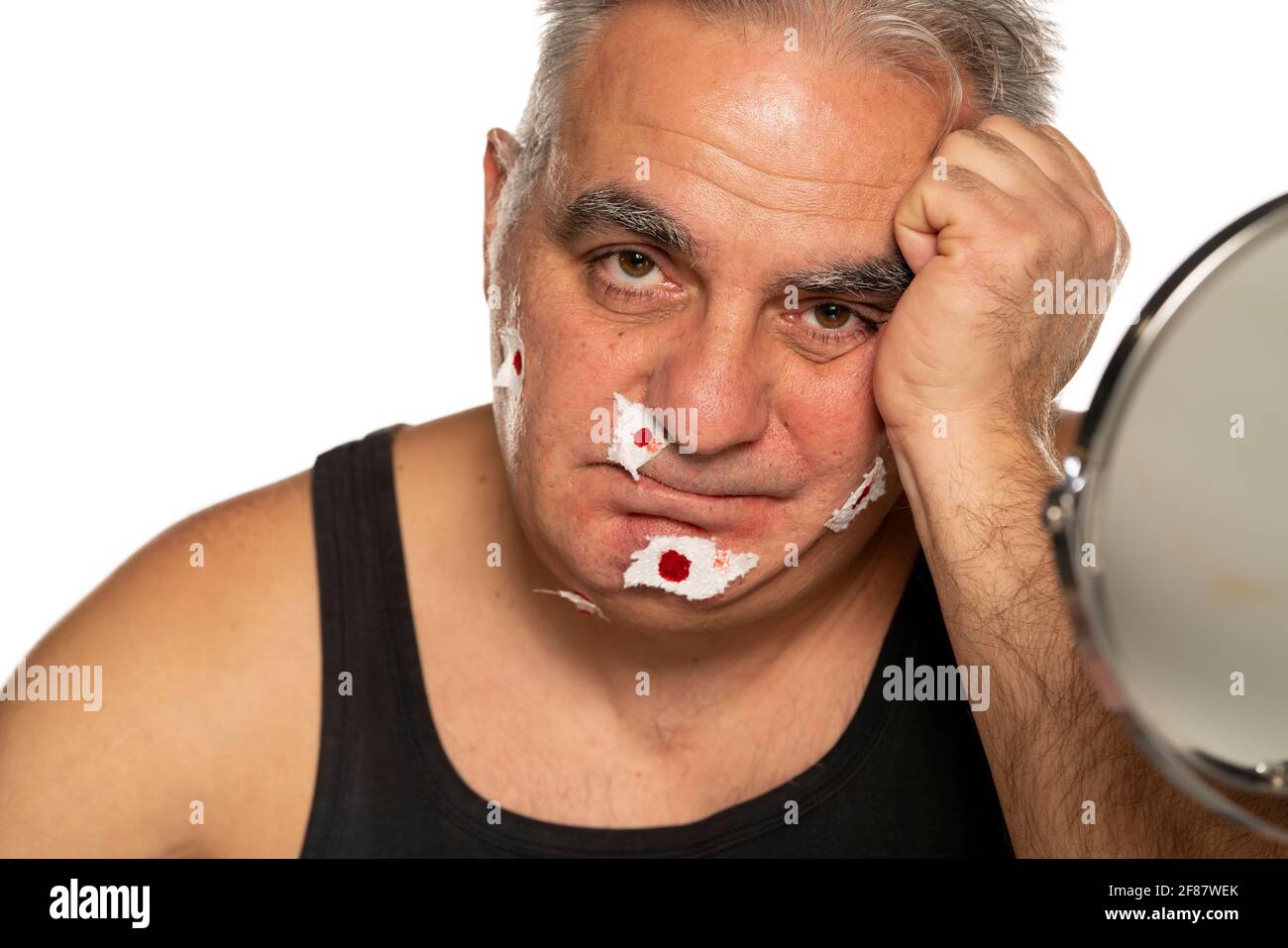 unhappy middle aged man with blood on his face on white background ...