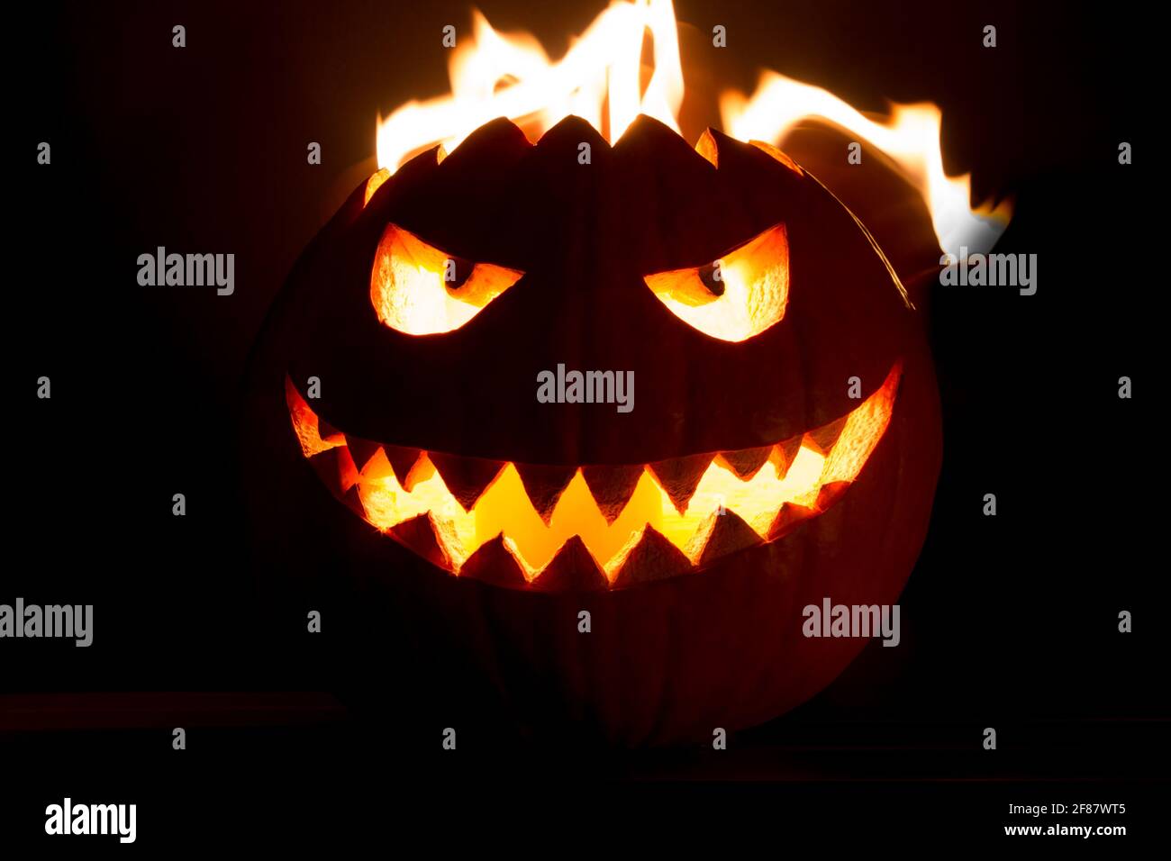Carved spooky halloween pumpkin with glowing hot fire flame head. Big ...