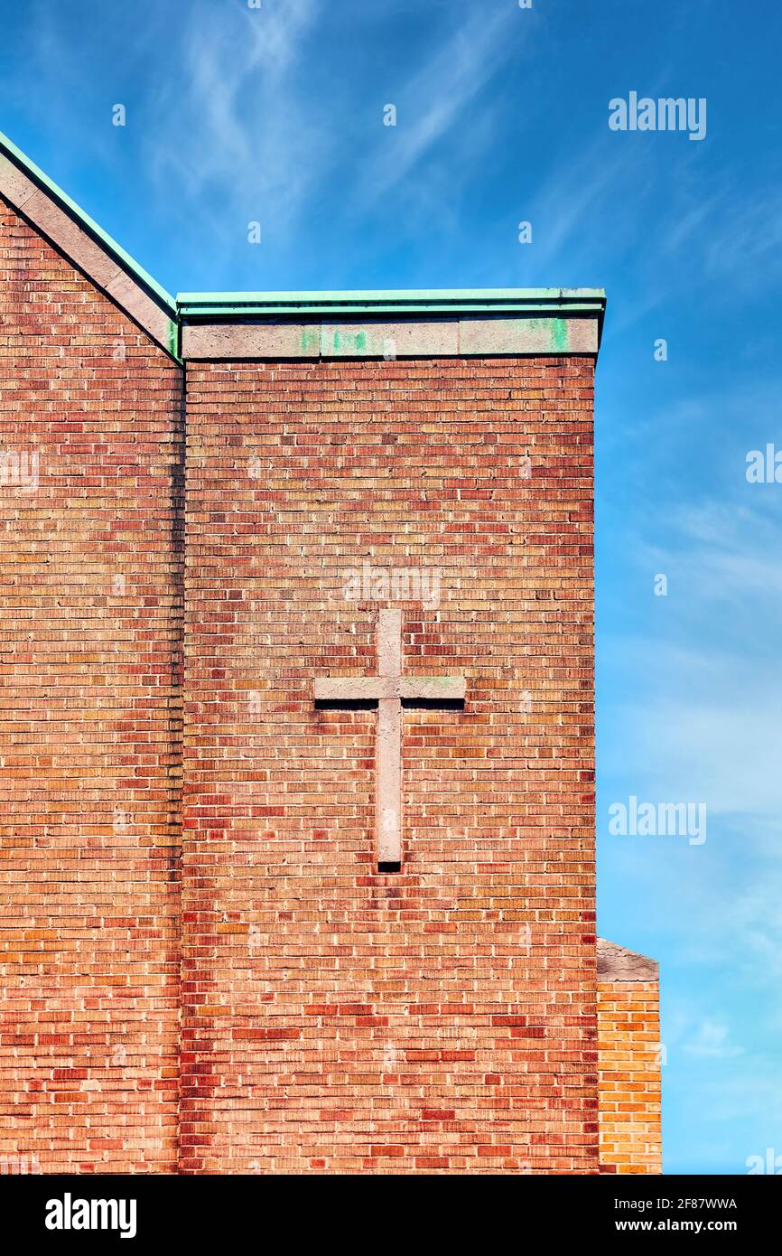 Embossed cross symbol on the exterior brick wall of a church building ...
