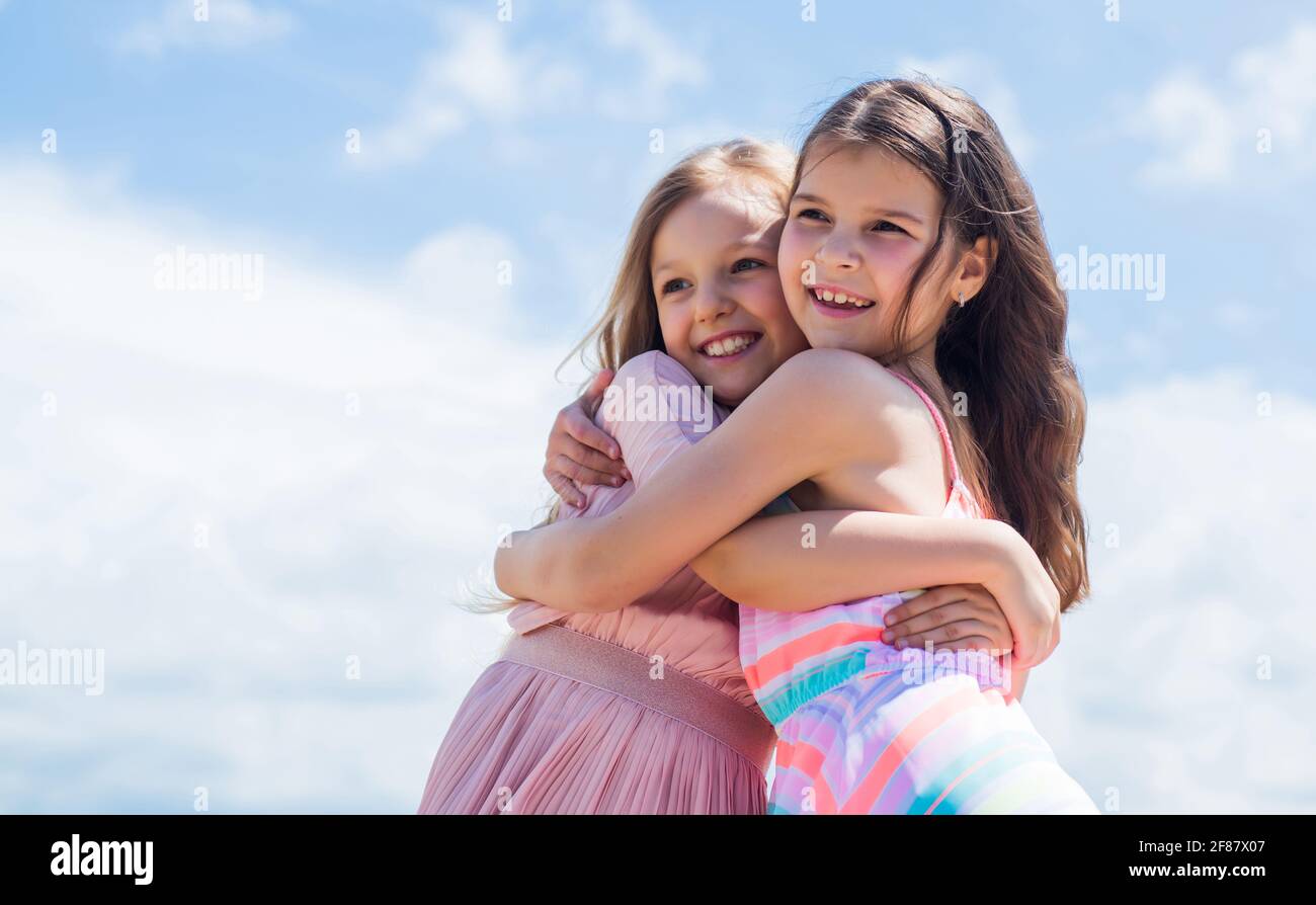 happy children embrace on sky background, family love Stock Photo - Alamy