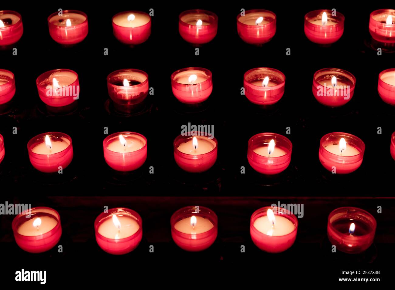Group of red candles in church for faith resurrection prayer ...