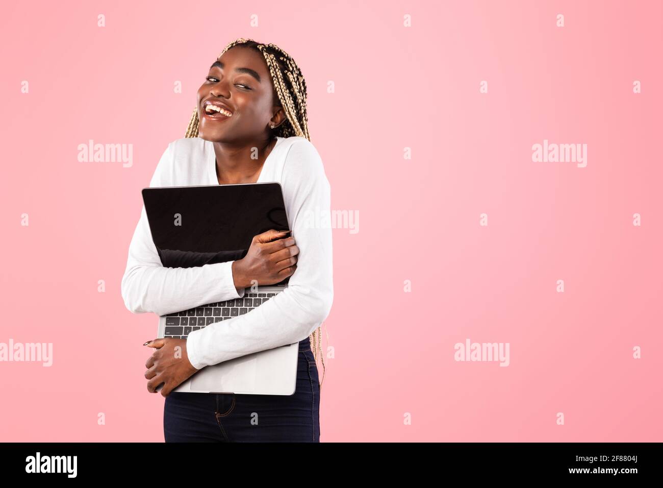 Technology Lover. Excite black woman hugging personal laptop computer ...