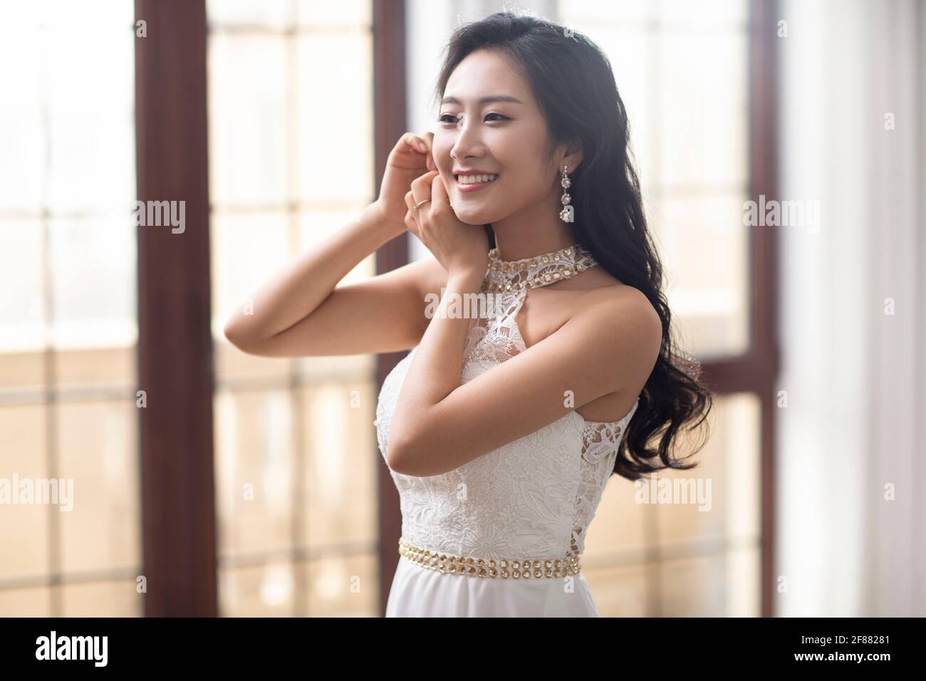 Happy young woman getting dressed at home Stock Photo - Alamy