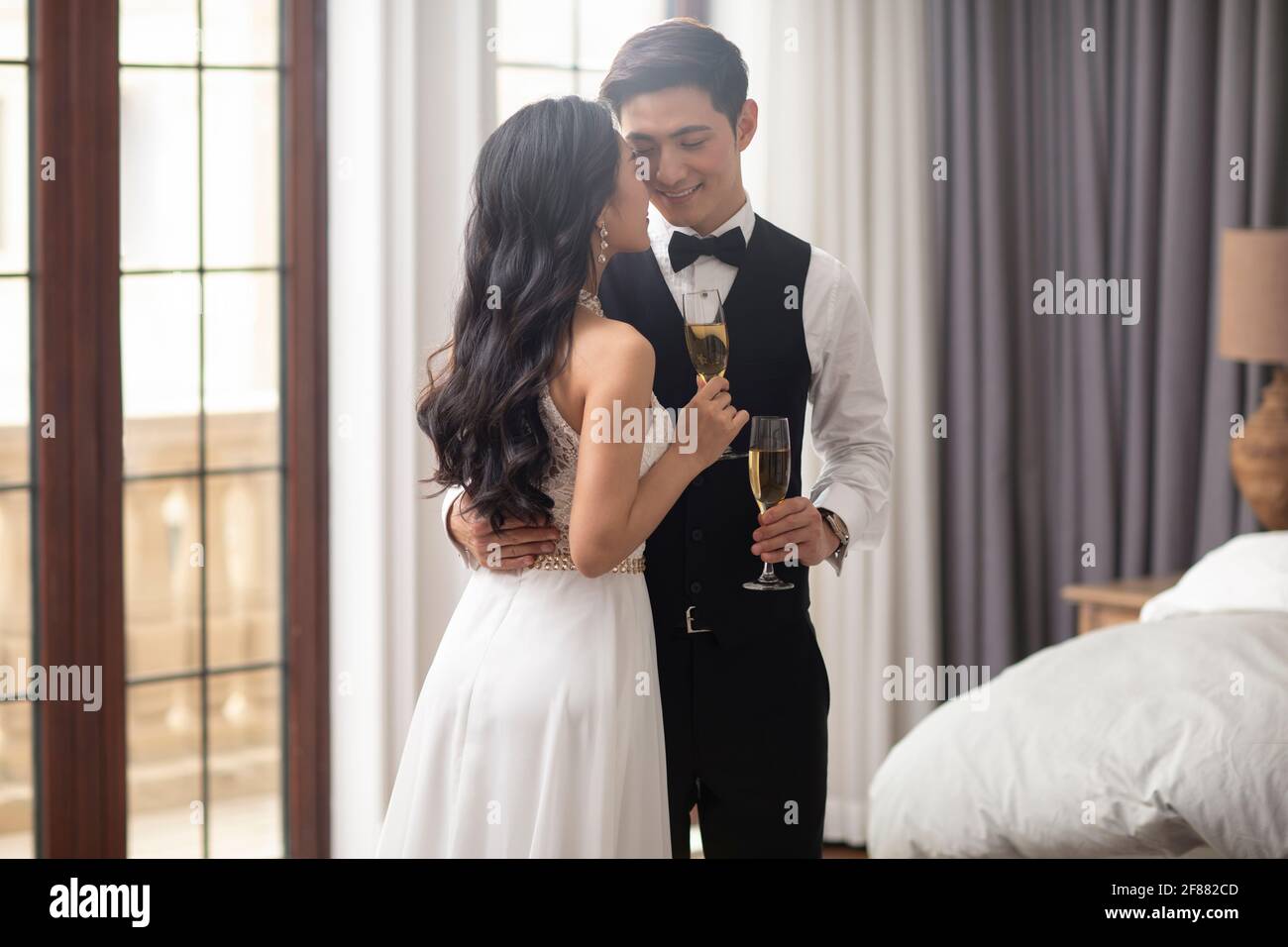 Happy young couple enjoying their love at home Stock Photo - Alamy