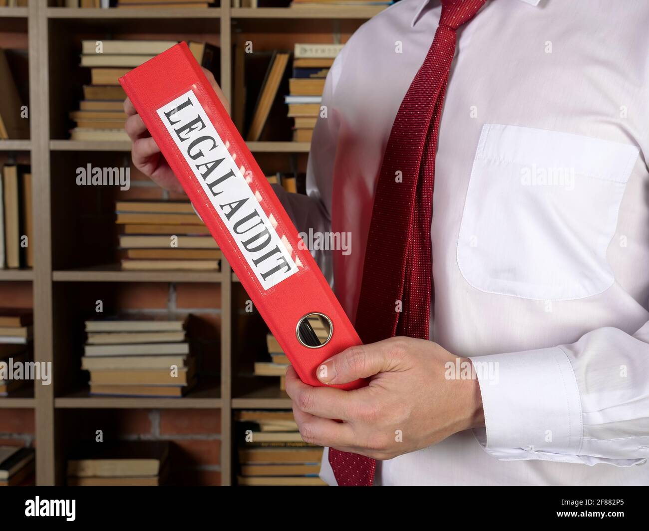 Folder with Legal audit label in the hands Stock Photo - Alamy