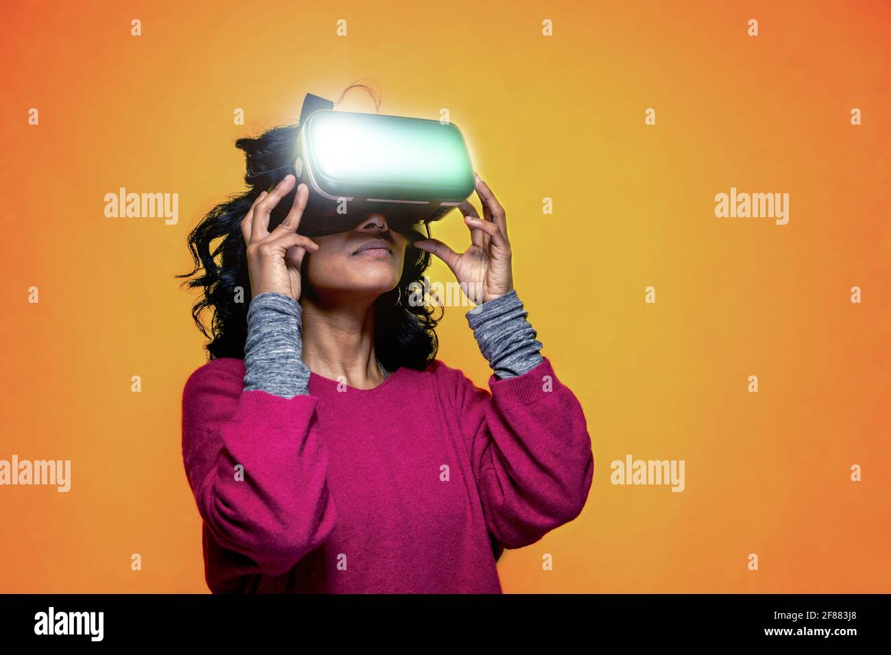 Beautiful young indian woman uses Vr glassess for augmented reality ...