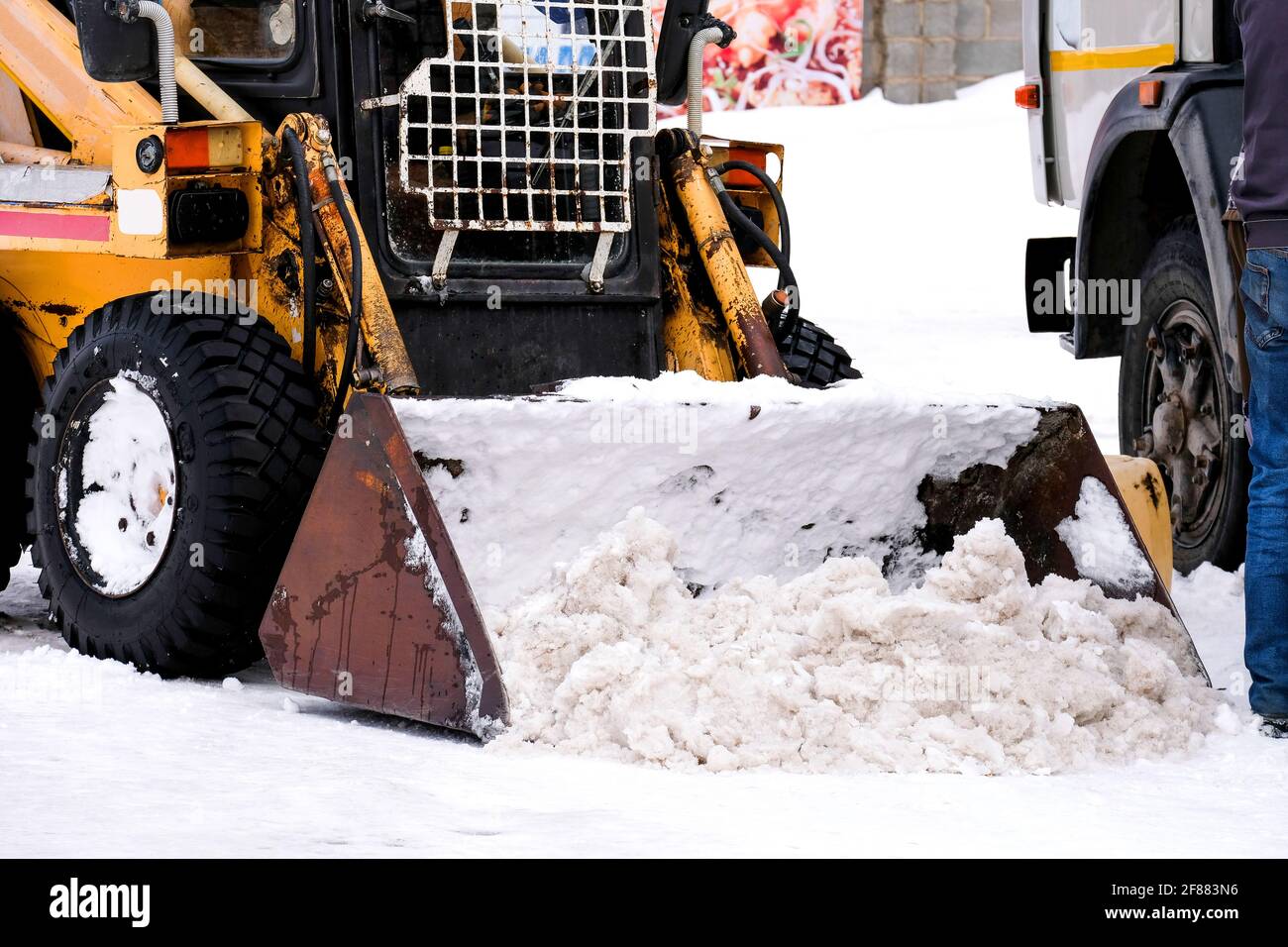 Small snow plow tractor. Snow Cleaner. Winter road works. Snowblower ...