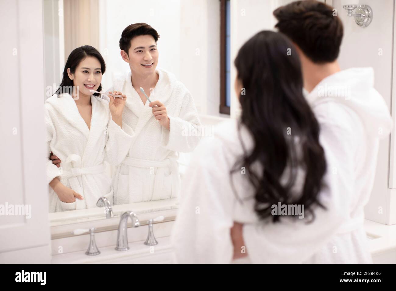 Happy asian couple brushing teeth hi-res stock photography and images ...