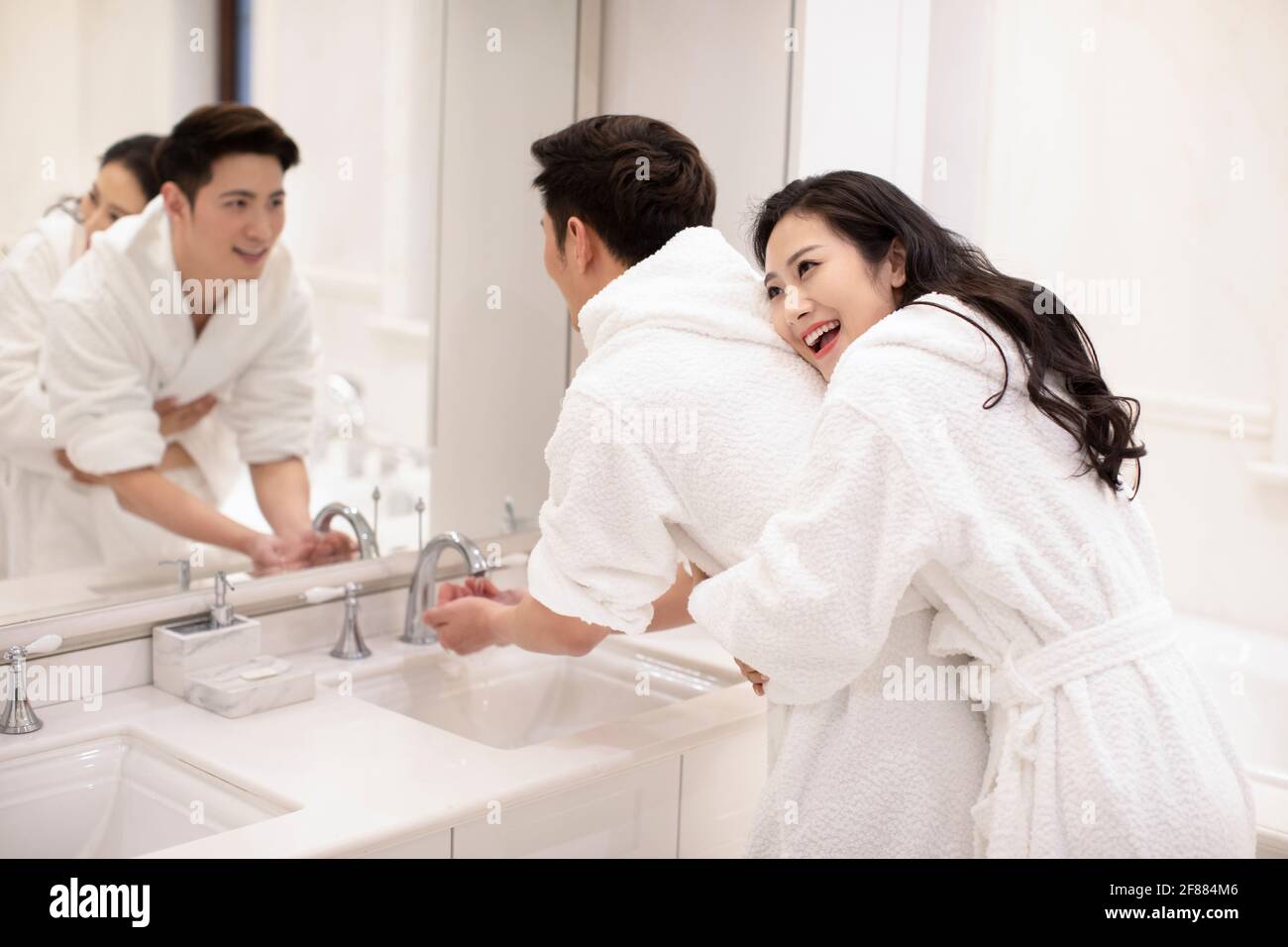Loving young couple in bathroom Stock Photo - Alamy