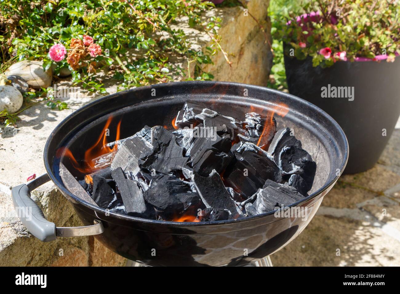 Barbecue lit in a garden before grilling meat Stock Photo - Alamy