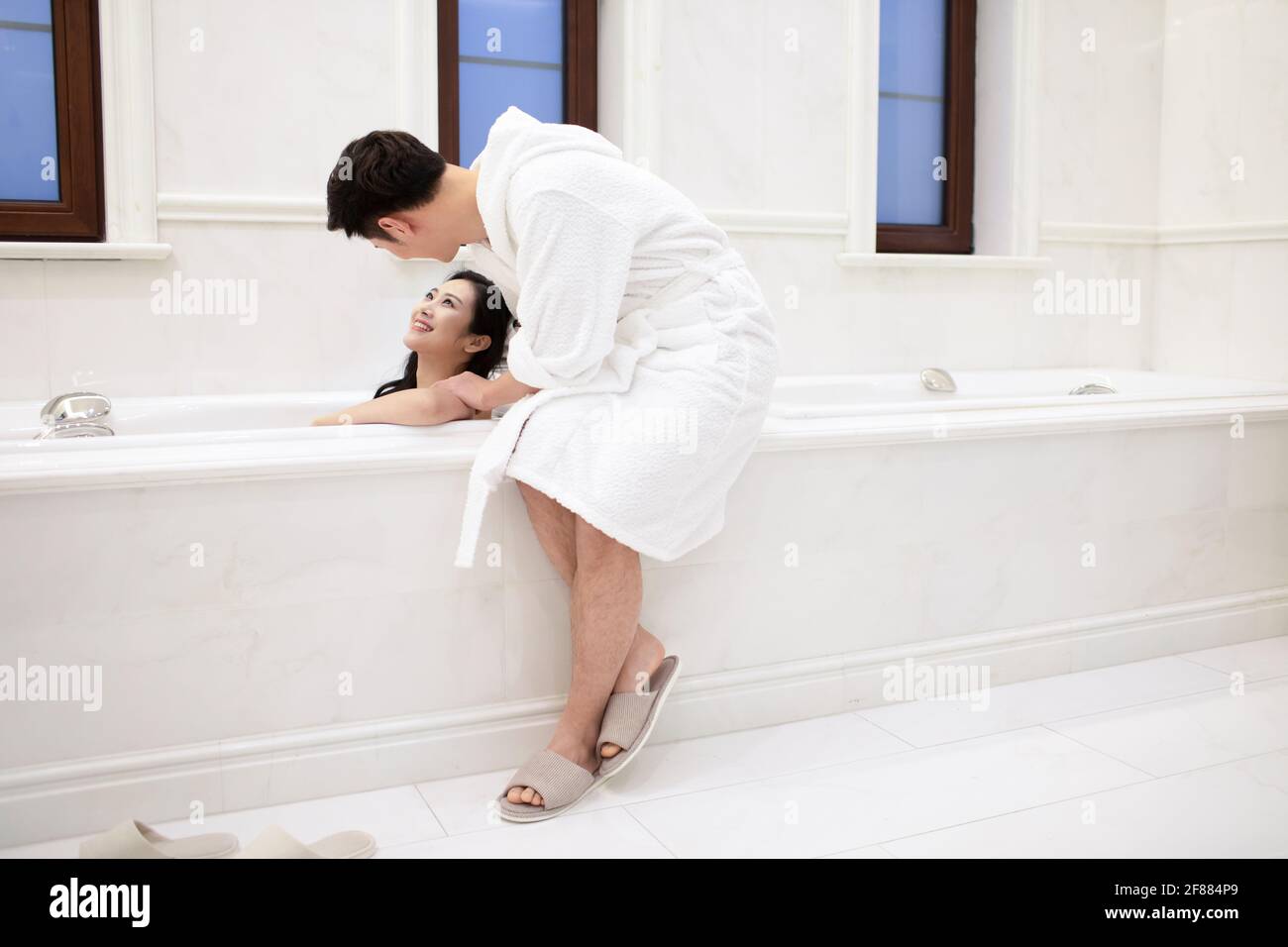 Loving young couple in bathroom Stock Photo - Alamy
