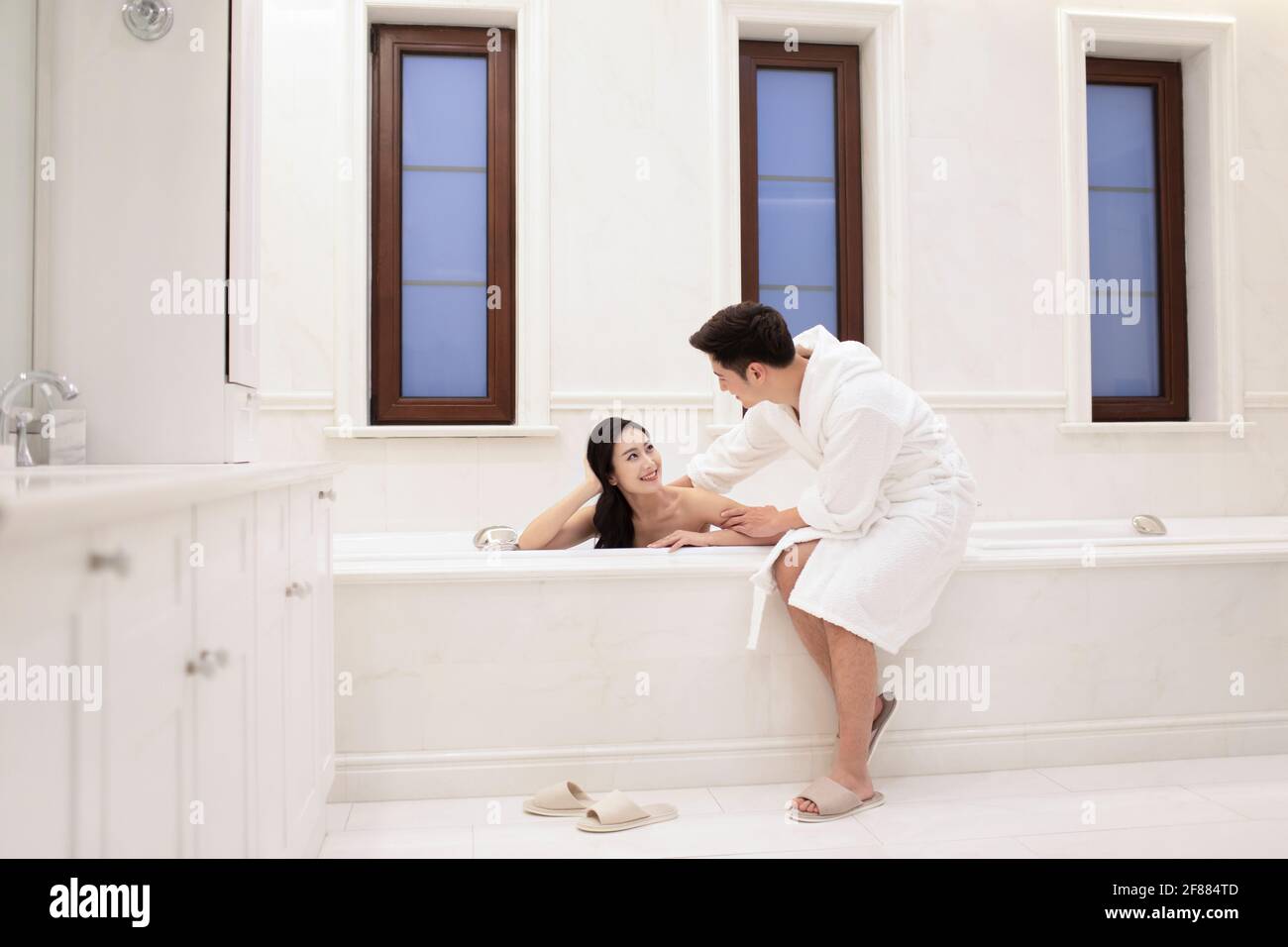 Loving young couple in bathroom Stock Photo - Alamy