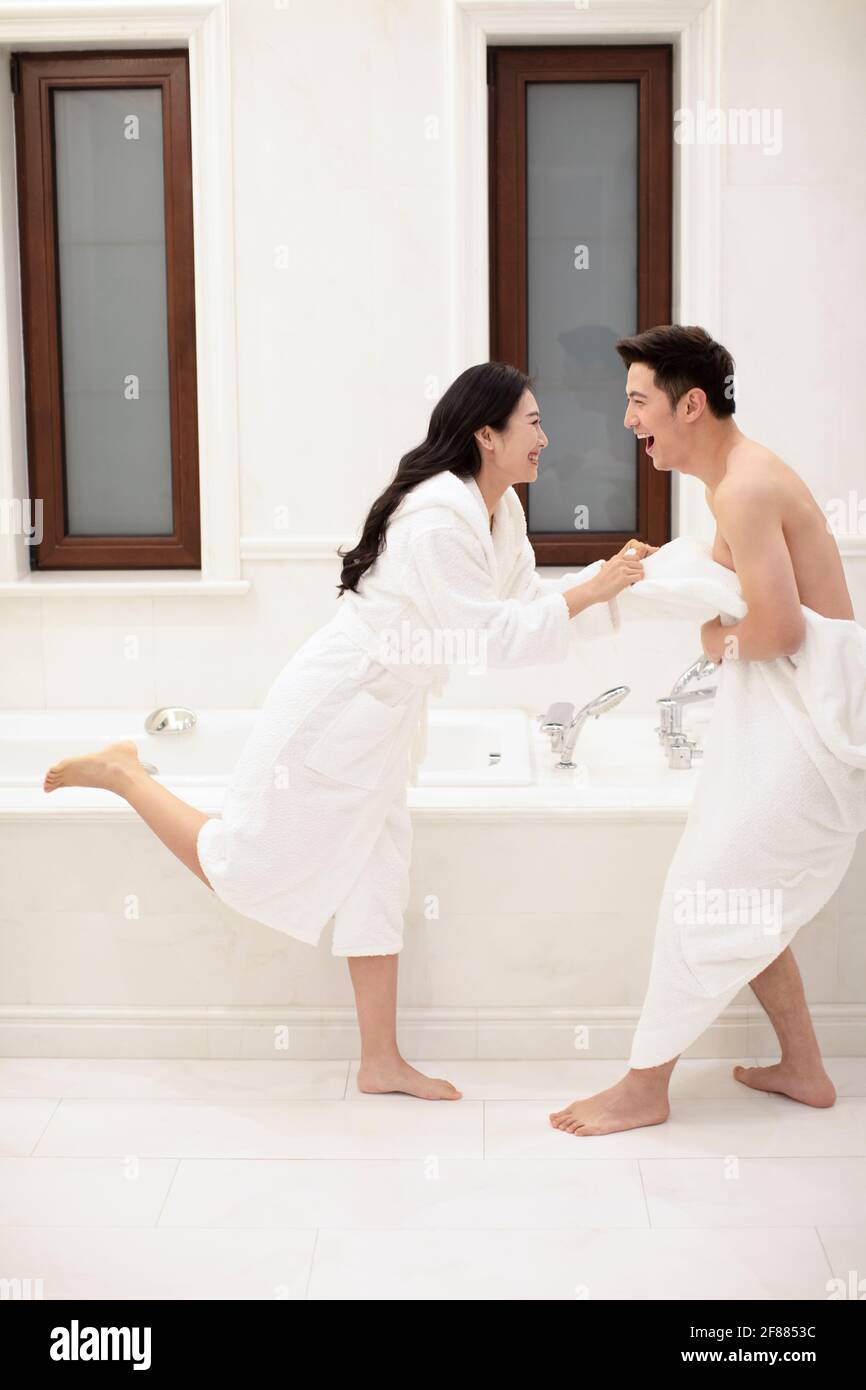 Loving young couple having fun in bathroom Stock Photo - Alamy