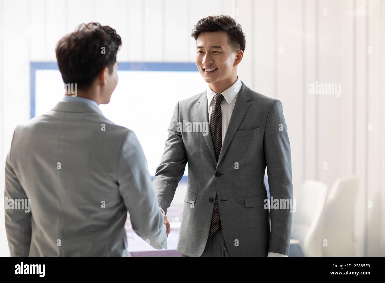 Over shoulder two businessmen talking hi-res stock photography and ...