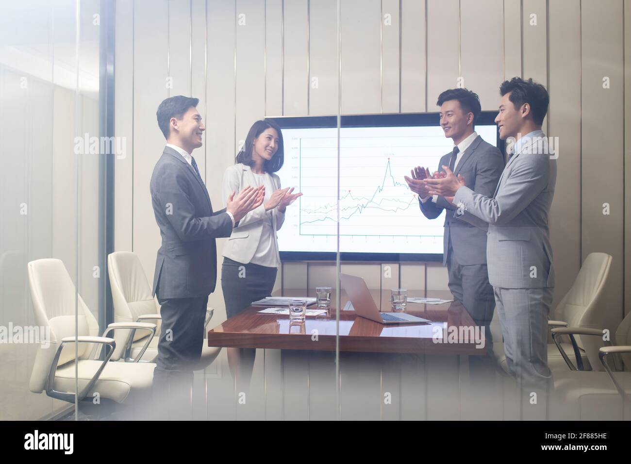 Business people clapping hands in conference room Stock Photo - Alamy
