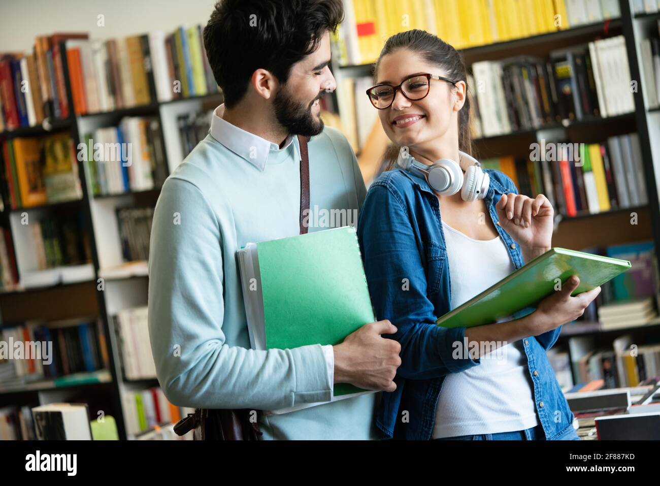 Enjoying student life. Smiling young happy students couple studying and ...