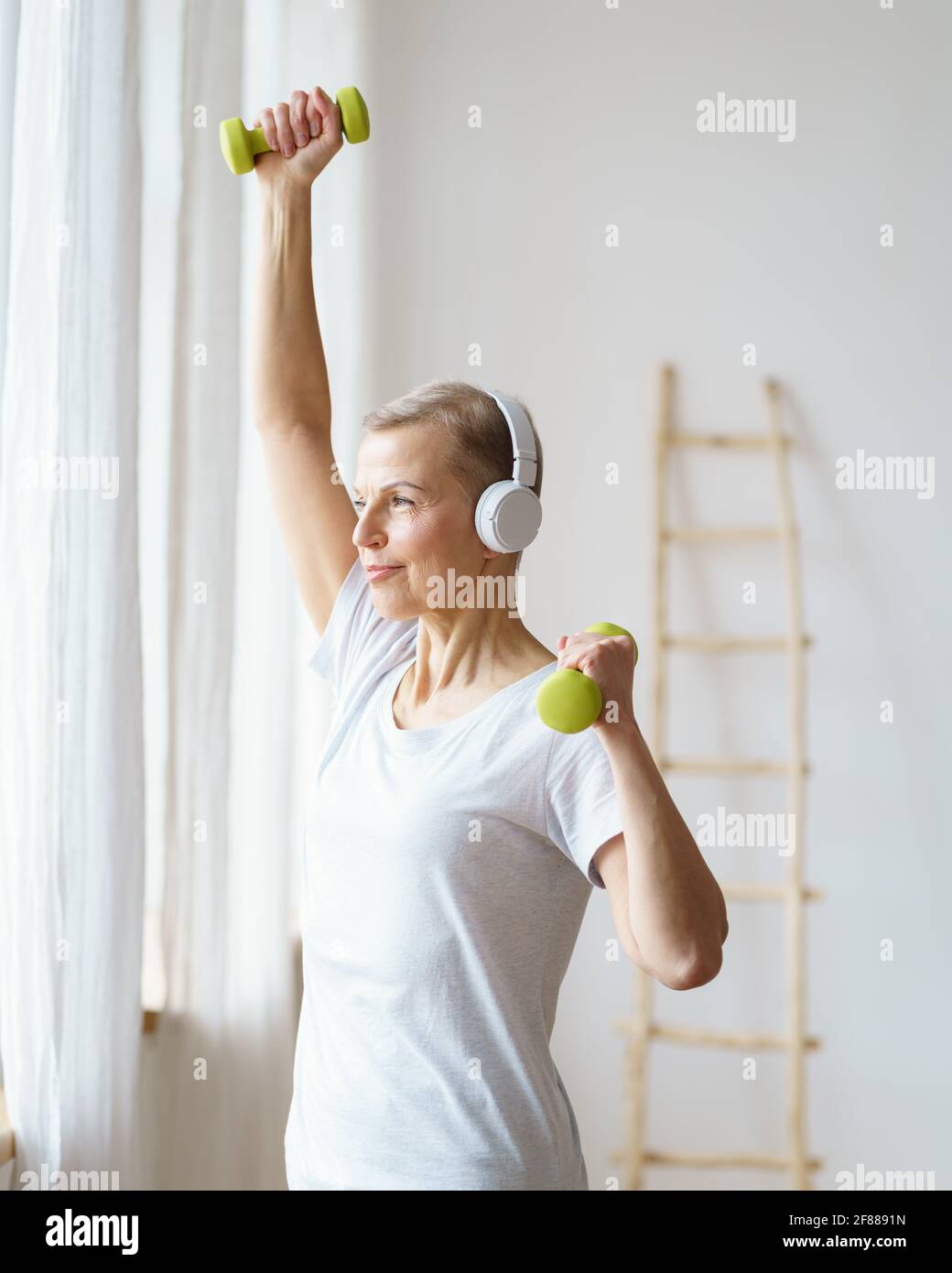 Mature woman training biceps hi-res stock photography and images - Alamy