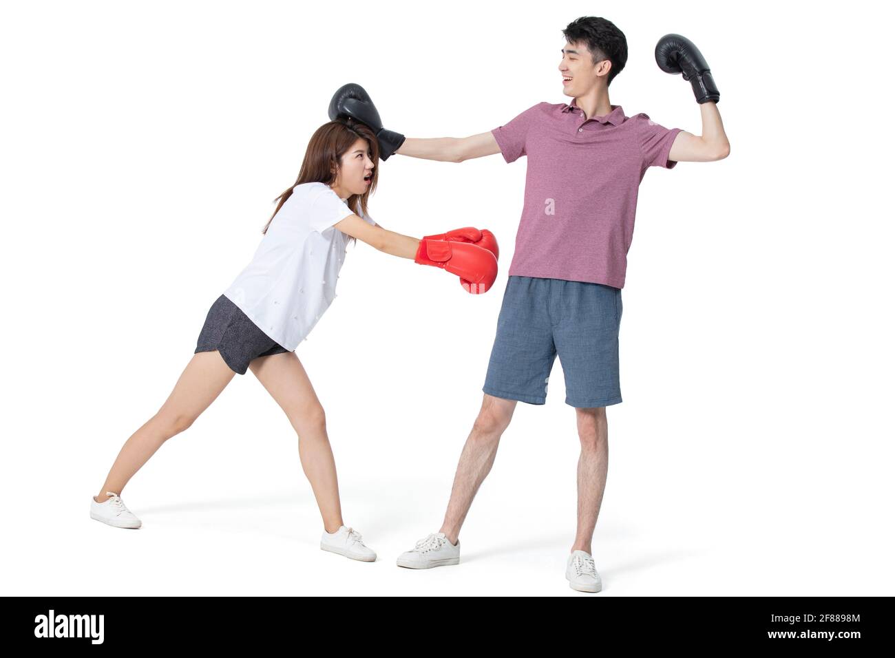 Humorous young couple practicing boxing Stock Photo - Alamy