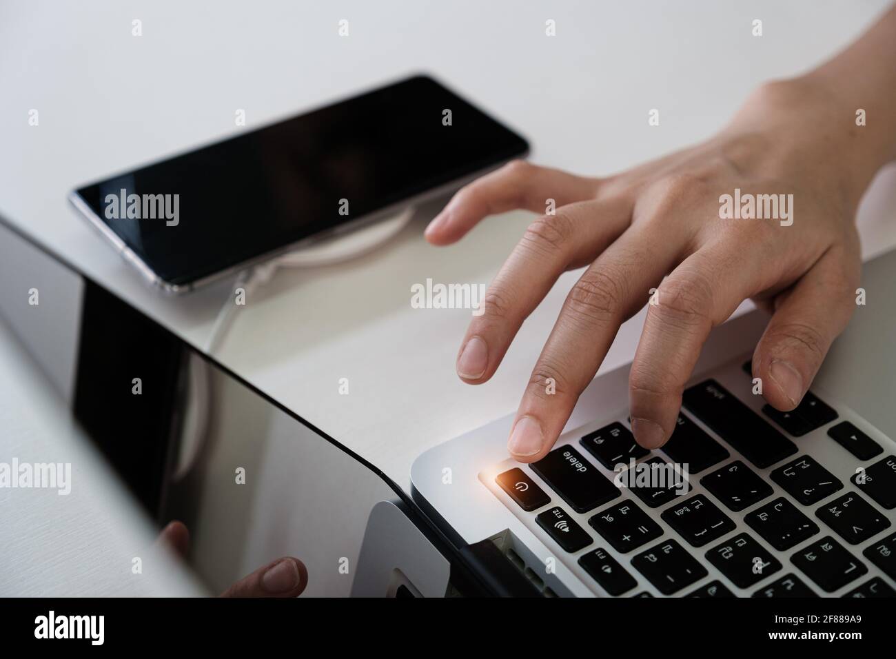 Man press turn off button laptop computer and turn off smartphone ...