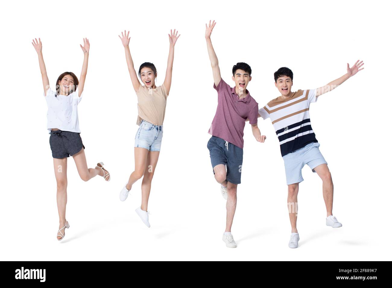 Cheerful young friends jumping together Stock Photo - Alamy