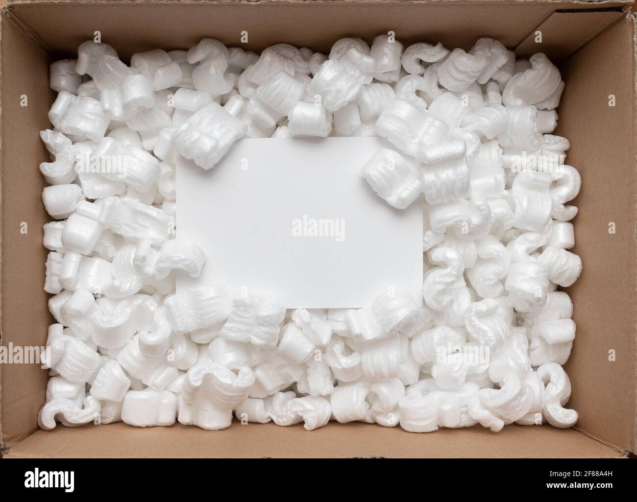 A cardboard box with packing styro foam pellets top view Stock Photo ...