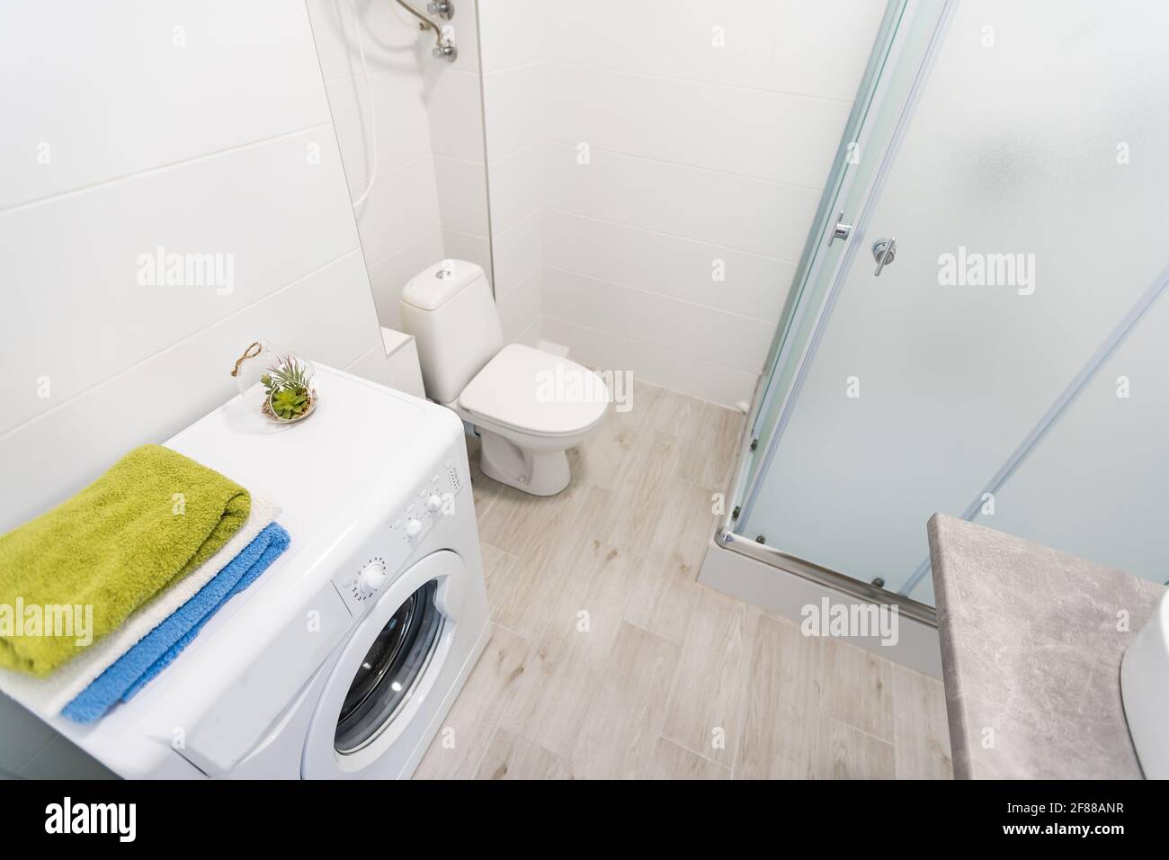 Washing machine in the bathroom, laundry Stock Photo - Alamy